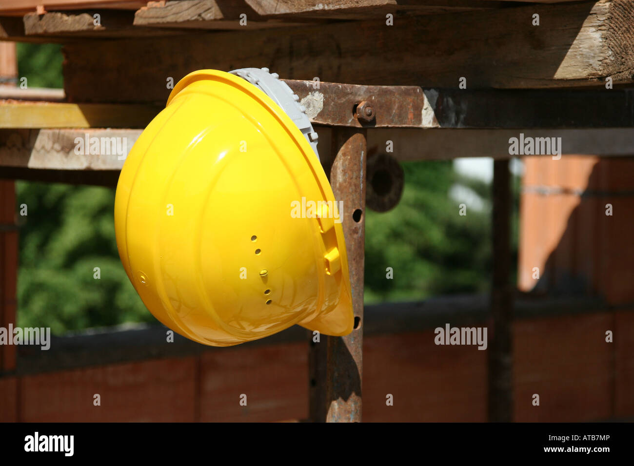 yellow work helmet on a building site Stock Photo - Alamy