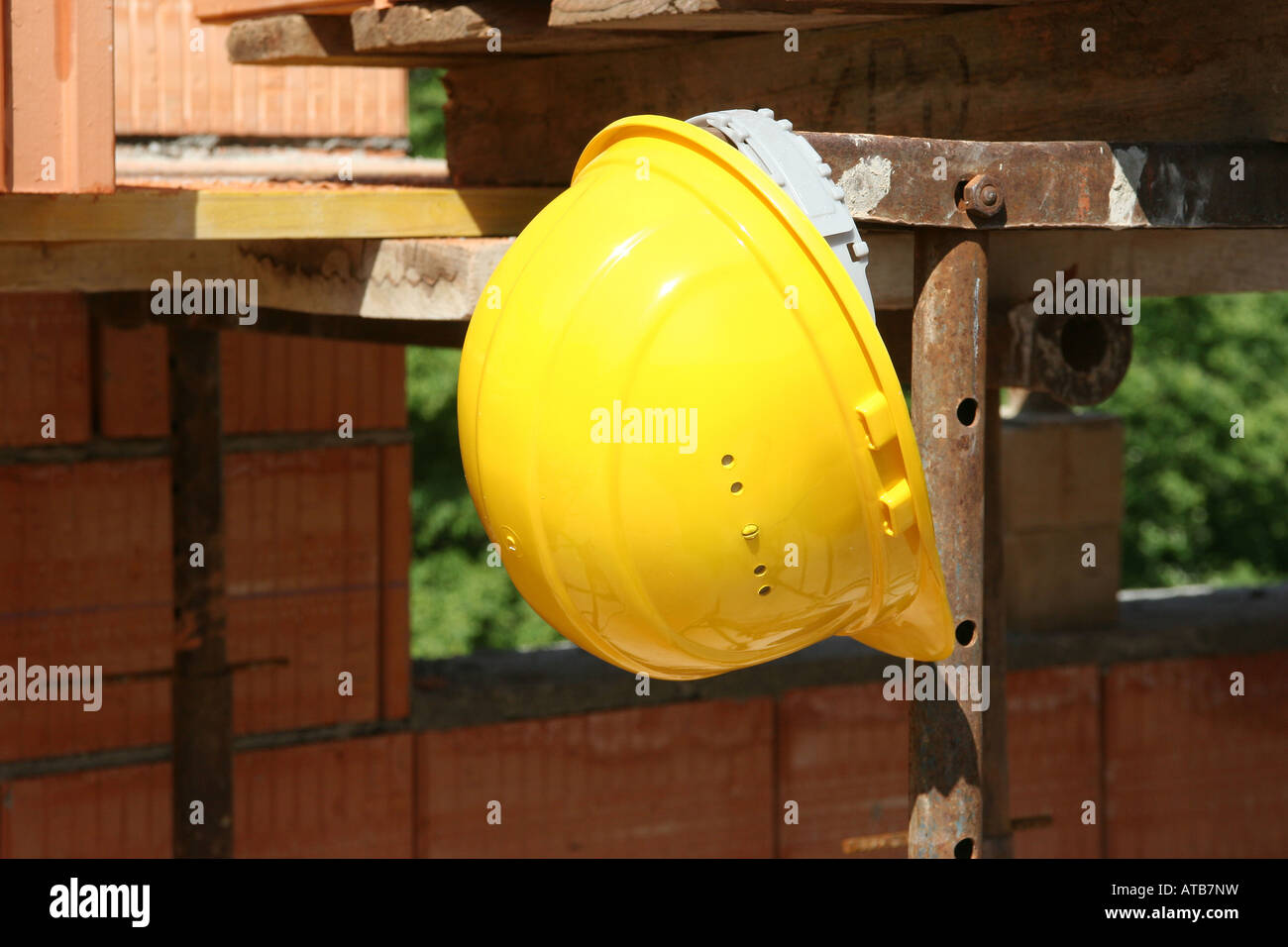 yellow work helmet on a building site Stock Photo - Alamy