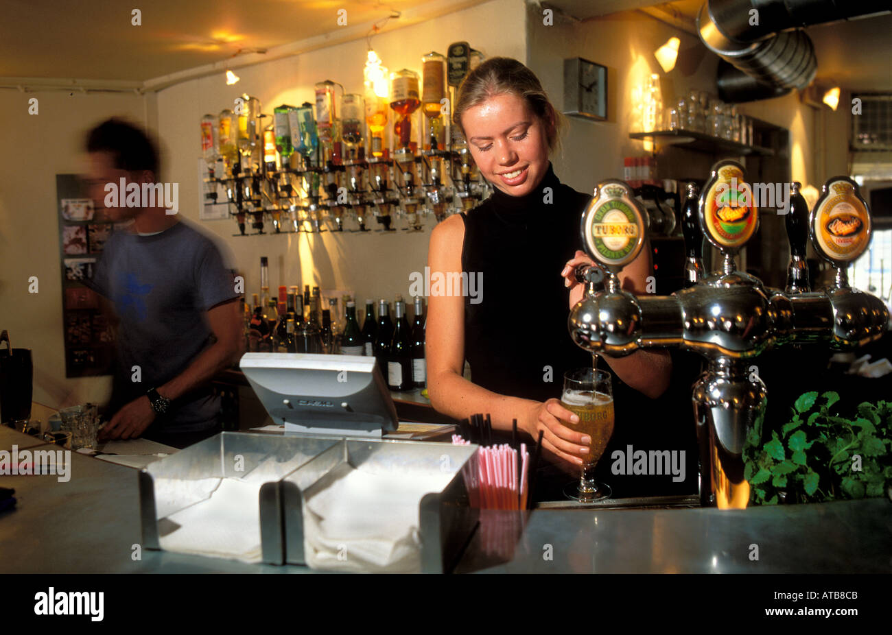 Denmark Copenhagen Barman serves beer at Kys cafe Stock Photo - Alamy