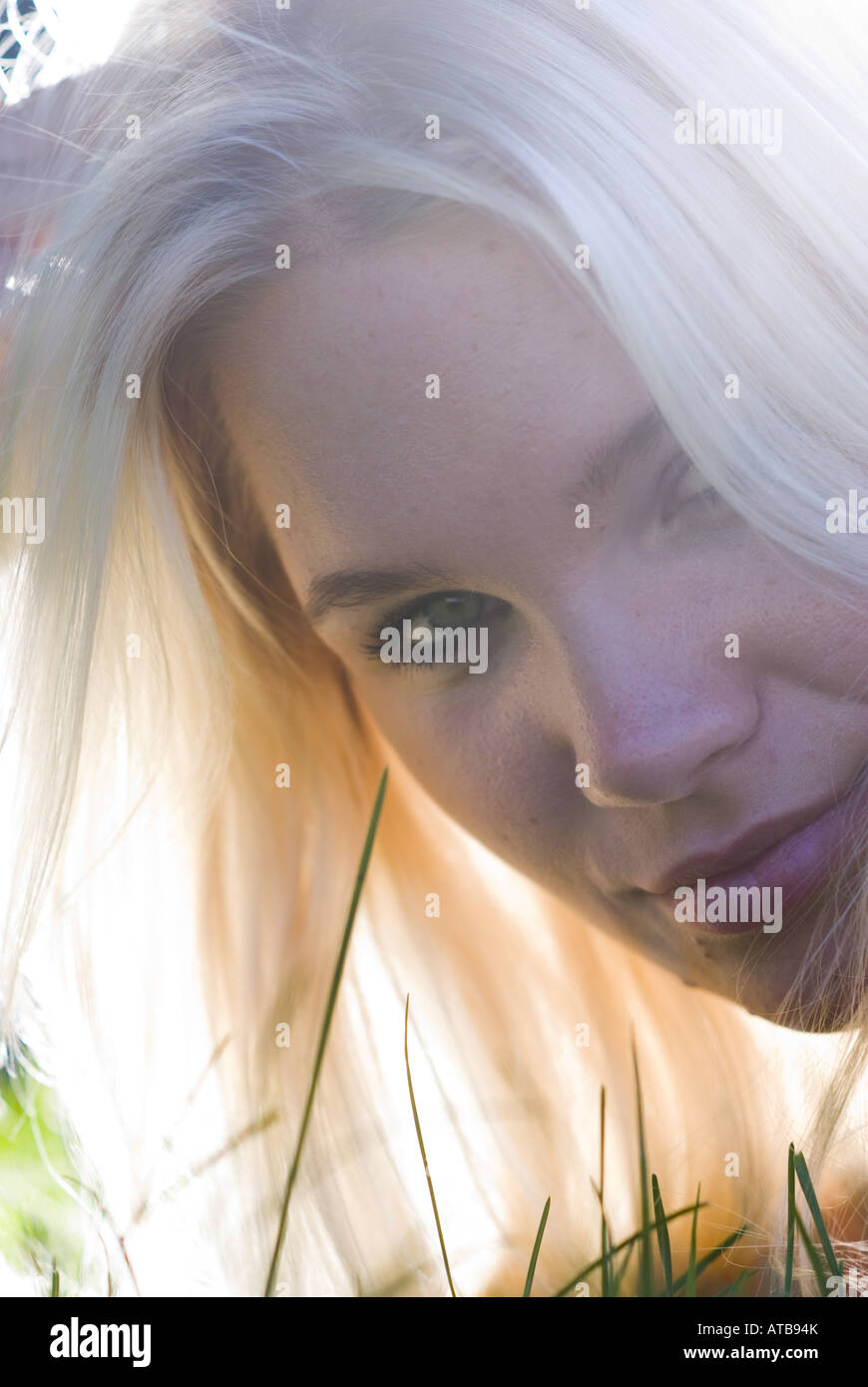 portrait of a young blond woman in backlight Stock Photo - Alamy