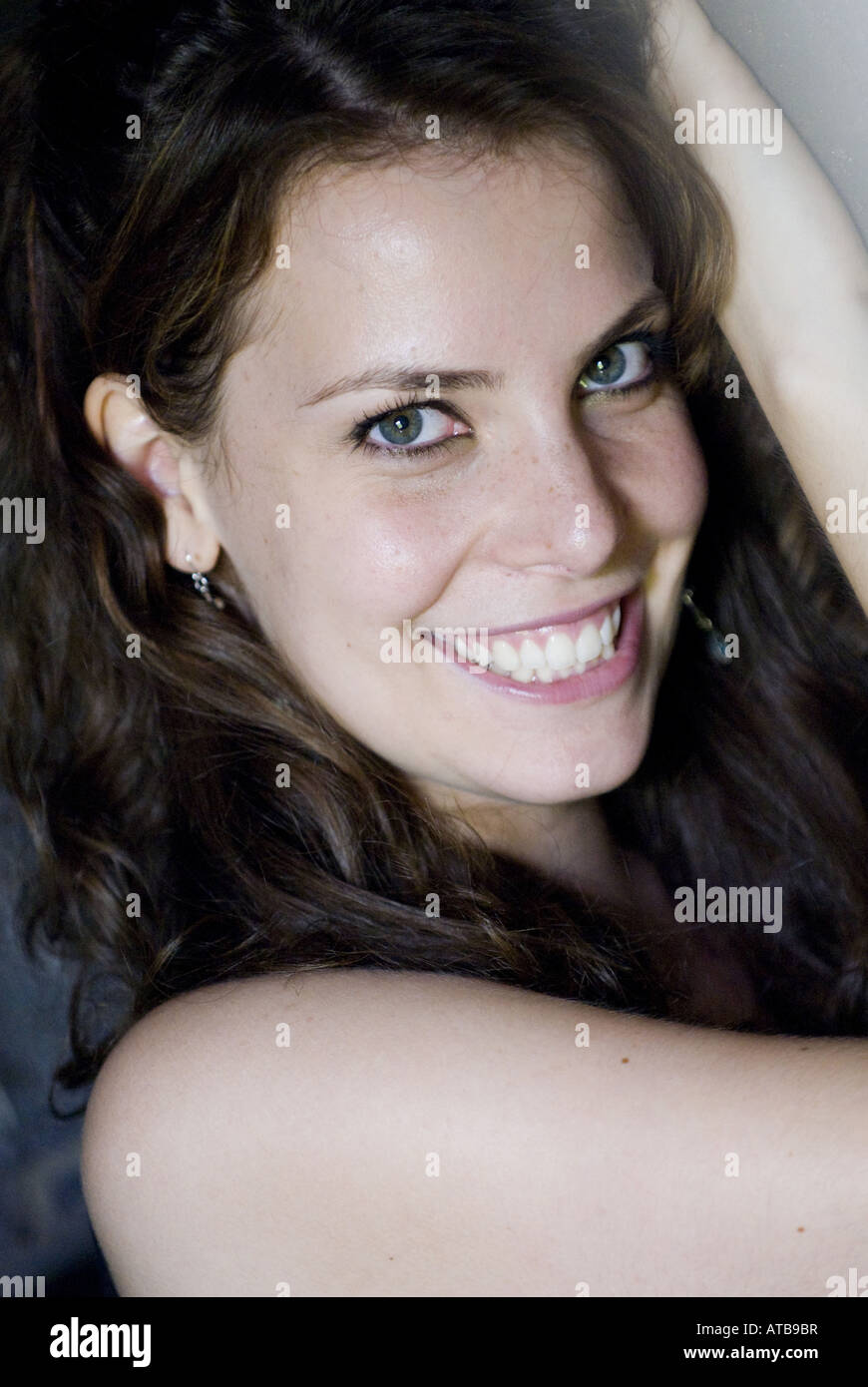 cute dark-haired women smiling into camera Stock Photo - Alamy