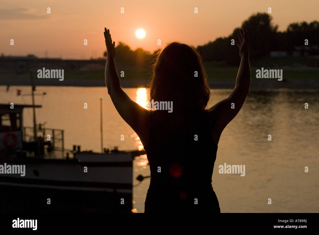 woman catching the sun, with outstretched arms Stock Photo - Alamy