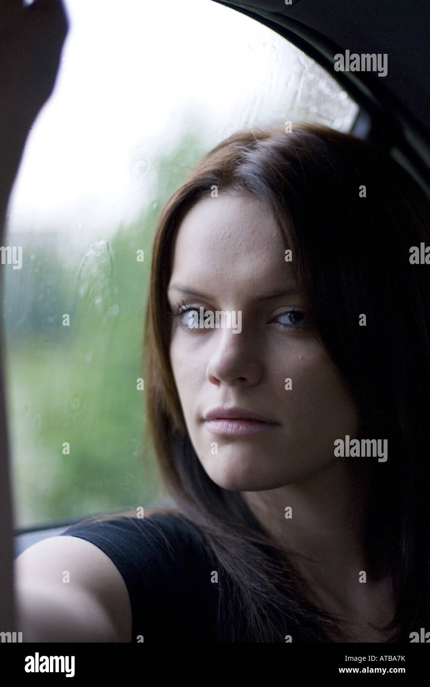 young woman in front ao a rainy window Stock Photo - Alamy