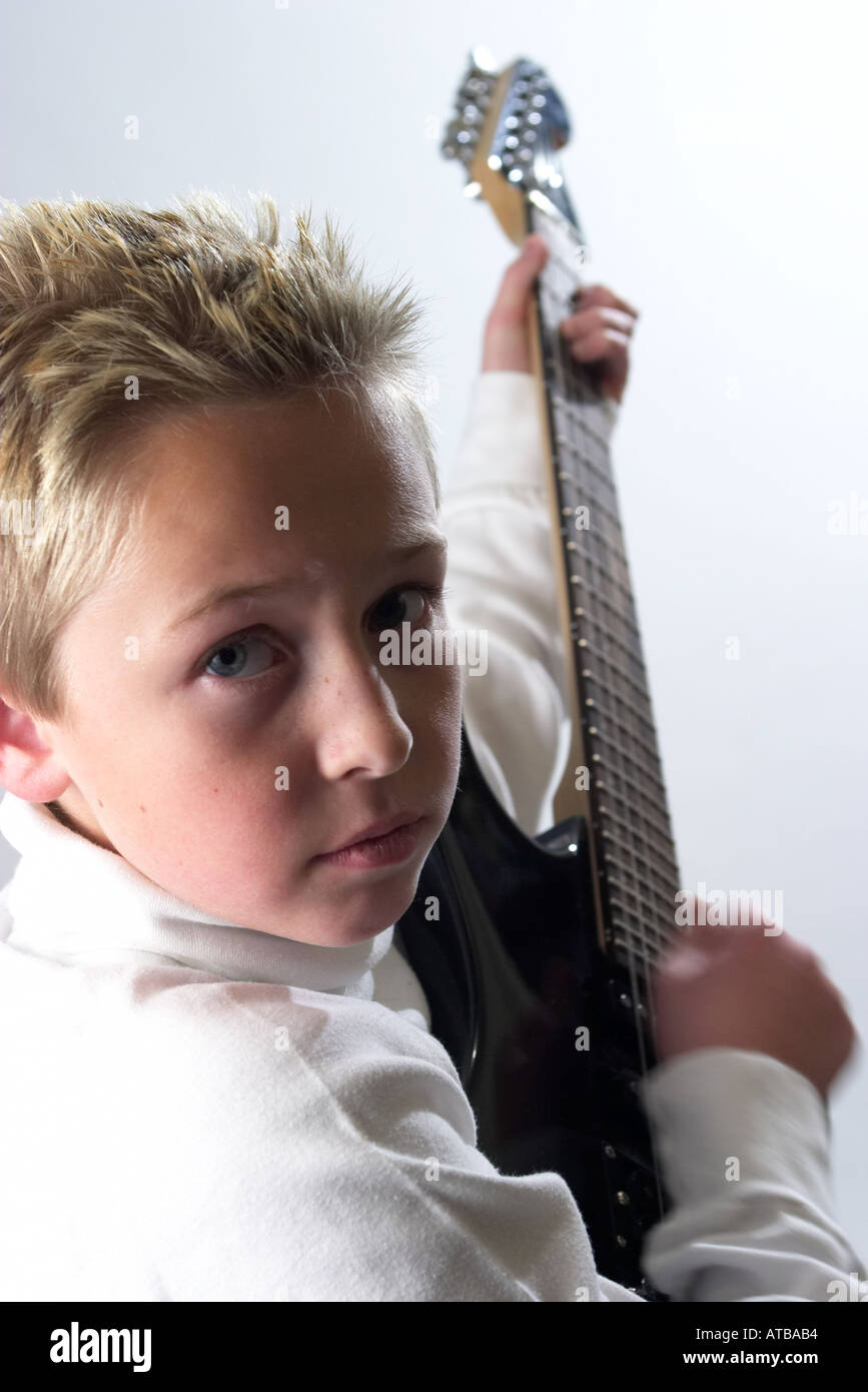 Boy playing electric guitar Stock Photo - Alamy