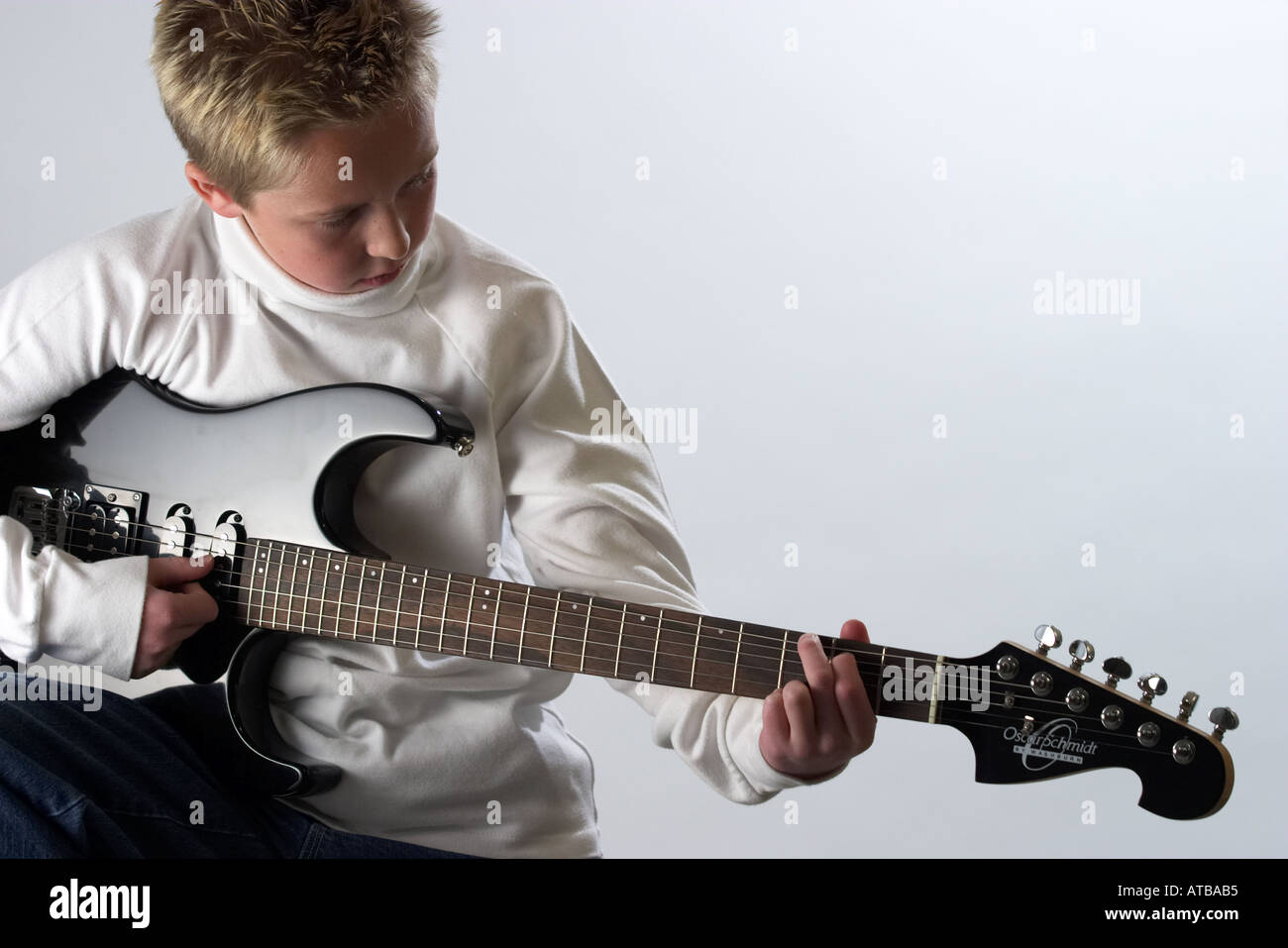 Boy playing electric guitar Stock Photo - Alamy