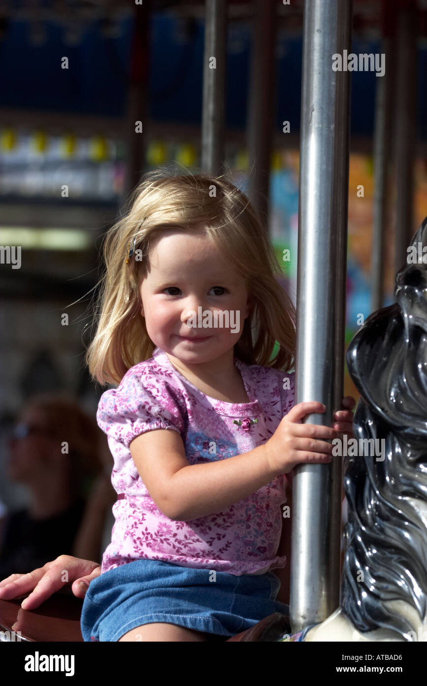 Girl on carousel ride Stock Photo - Alamy