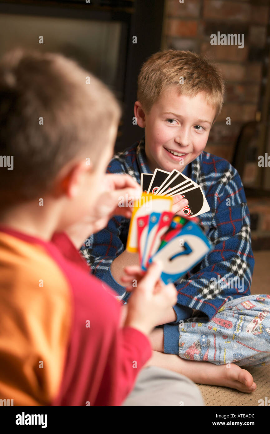 Two boys playing cards Stock Photo - Alamy