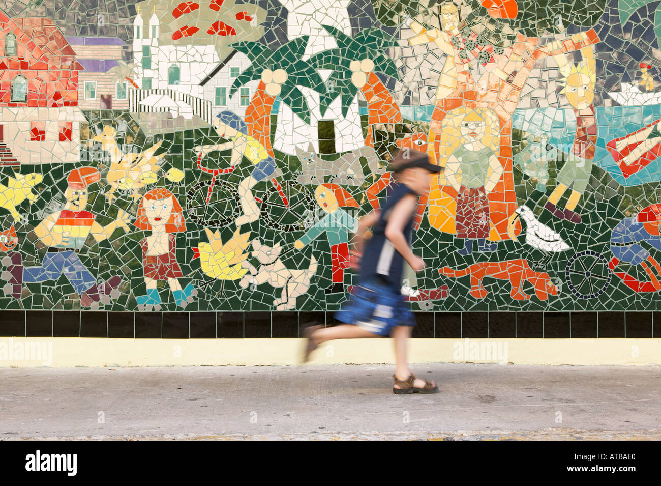 Boy running in front of colourful street mural Stock Photo - Alamy