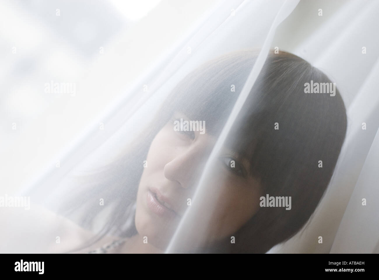 young woman behind a curtain Stock Photo - Alamy