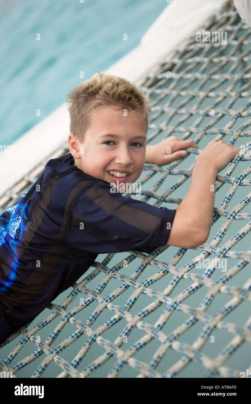 Boy on Catamaran netting Stock Photo - Alamy