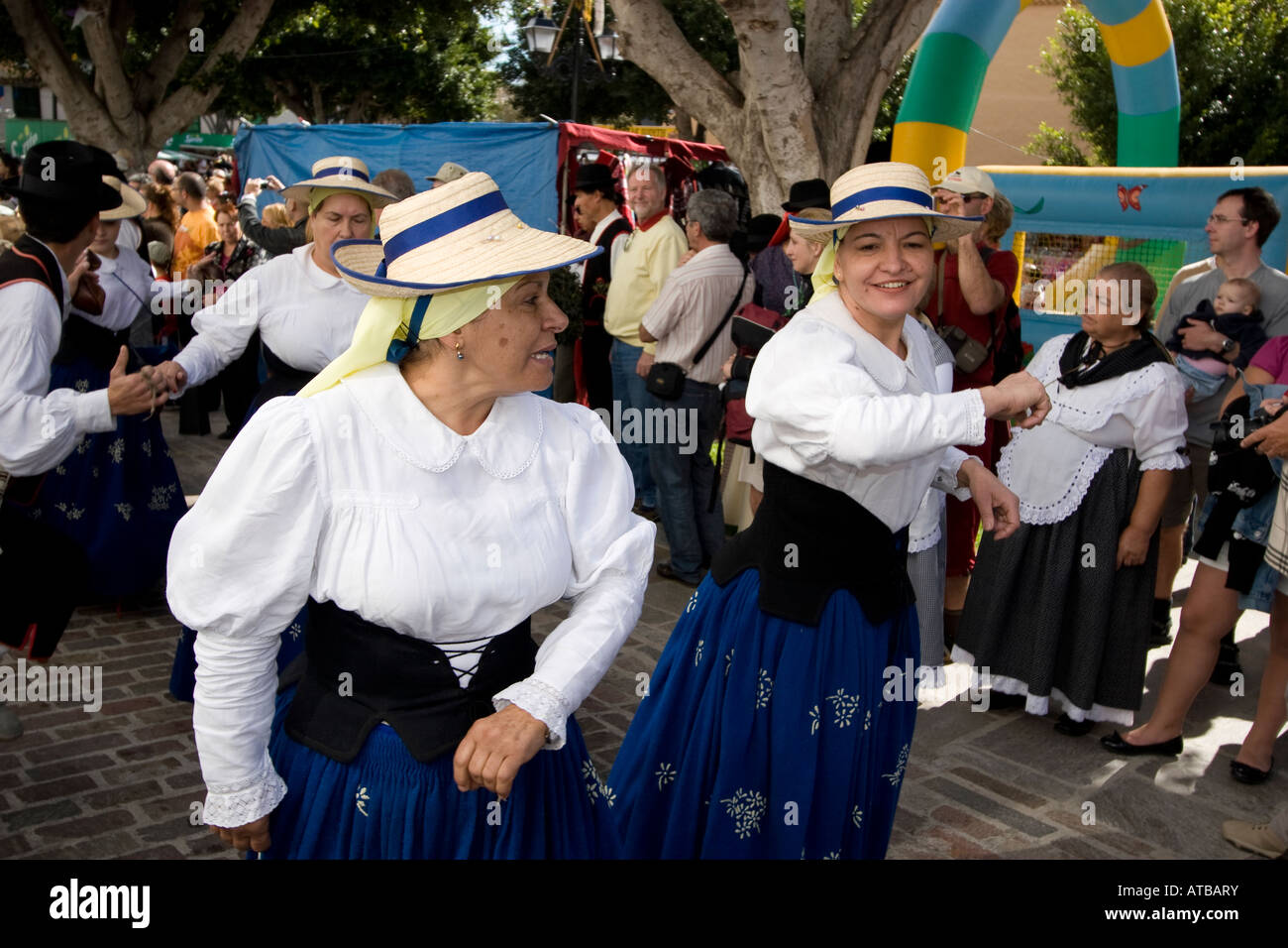 women in traditional Canarian costume dancing in a street festival in ...