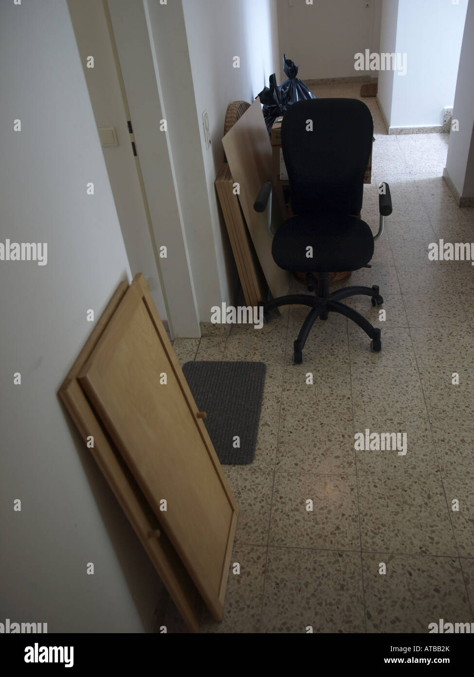 corridor of a flat at a a move with a swivel chair and parts of ...