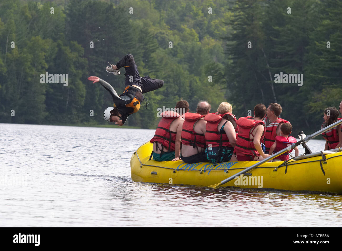 White water rafting guide jumping off raft Stock Photo - Alamy