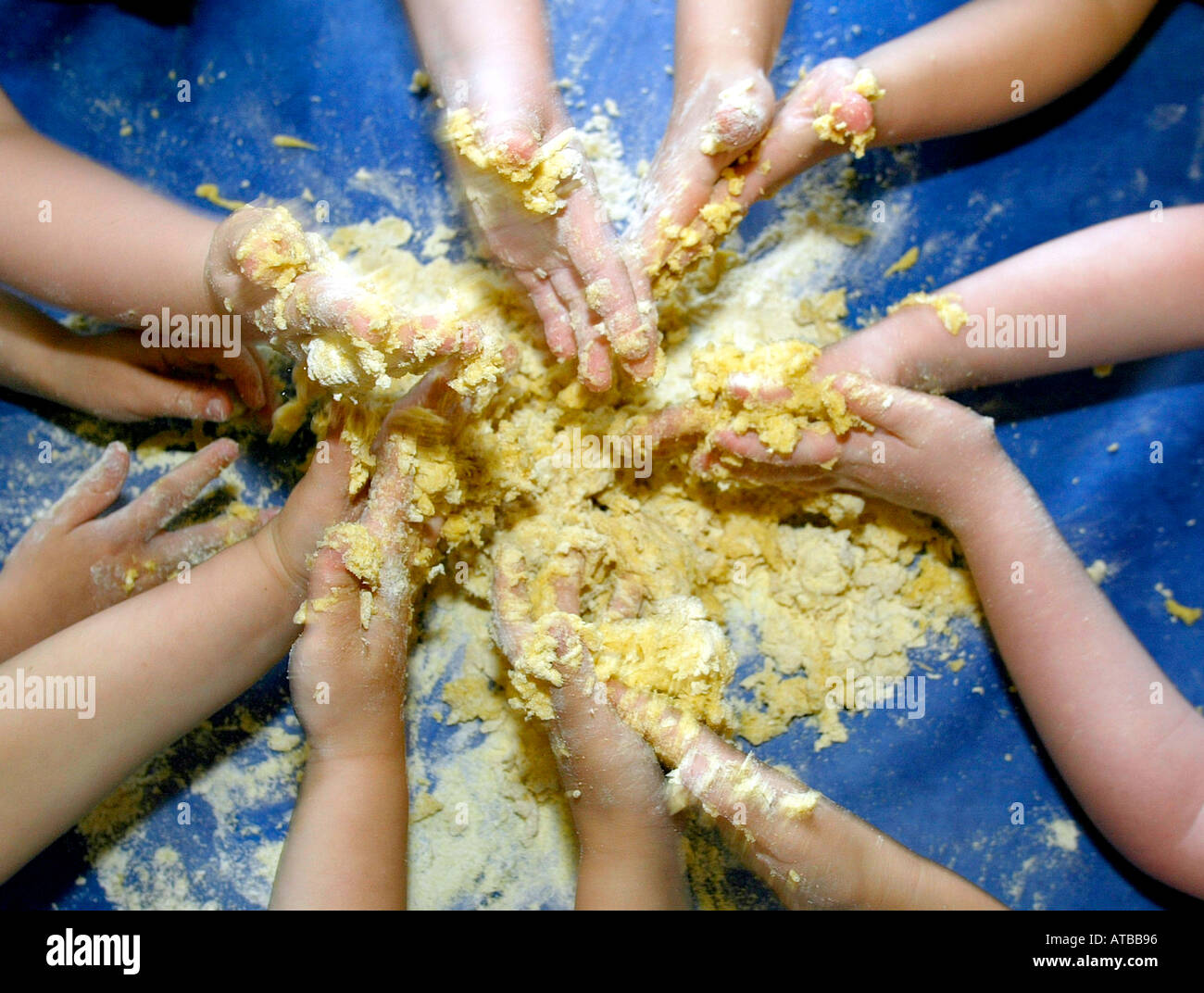 Children using their hands to mix baking ingredients Stock Photo - Alamy