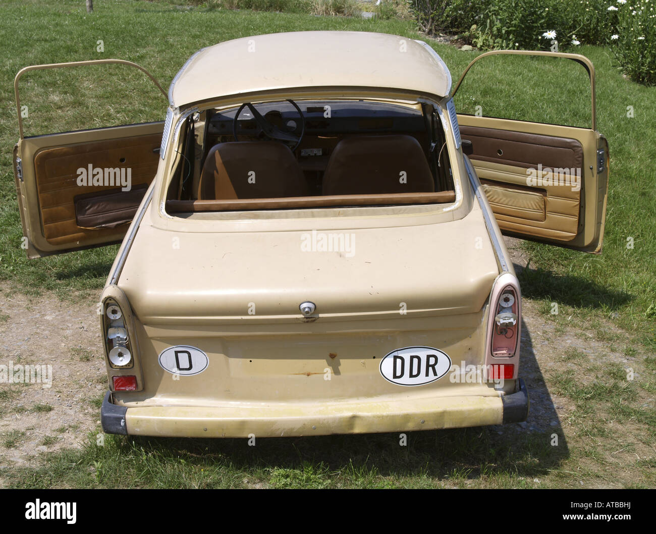 Trabant standing on a lawn with open doors and license plates of ...