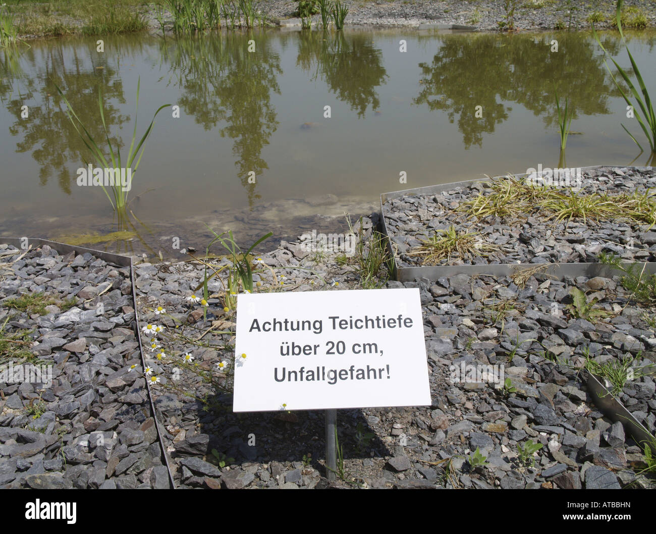 warning sign for lowness of a artificial lake, Germany Stock Photo - Alamy