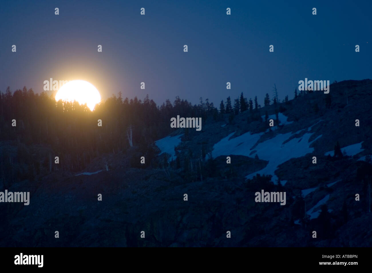 Full moon rising in evening over mountain ridge Desolation Wilderness ...