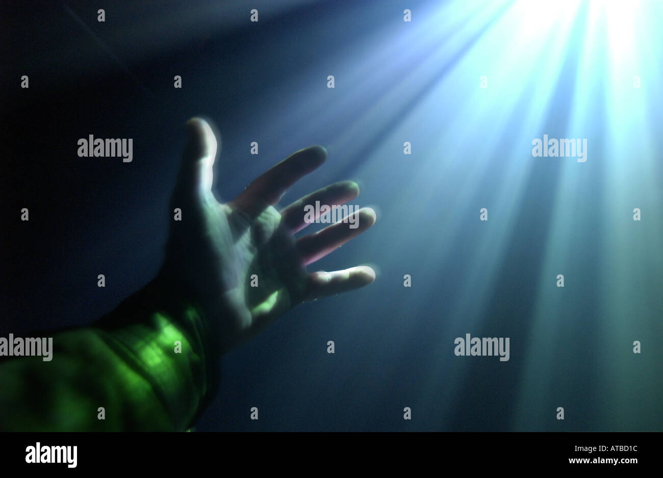 hand reaching out in a ray of light, photo by Bruce Miller Stock Photo ...