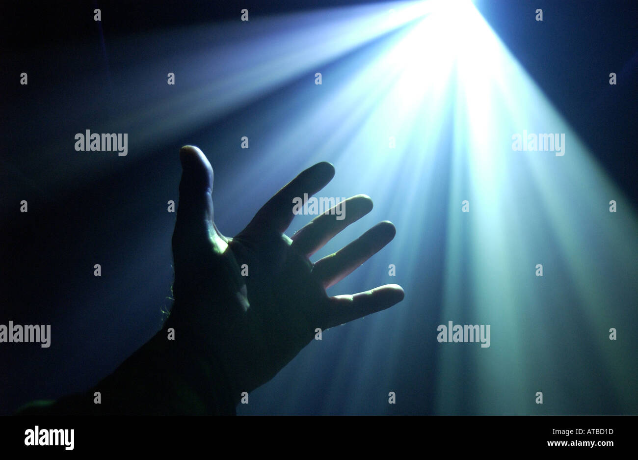 hand reaching out in a ray of light, photo by Bruce Miller 2002 Stock ...
