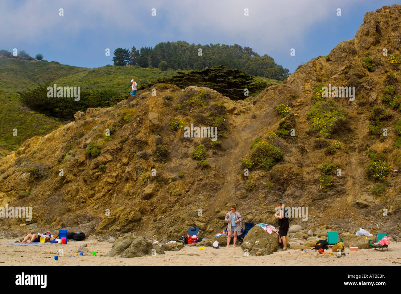Man climbing on coastal cliffs at Pfeiffer Beach Big Sur Coast Monterey ...