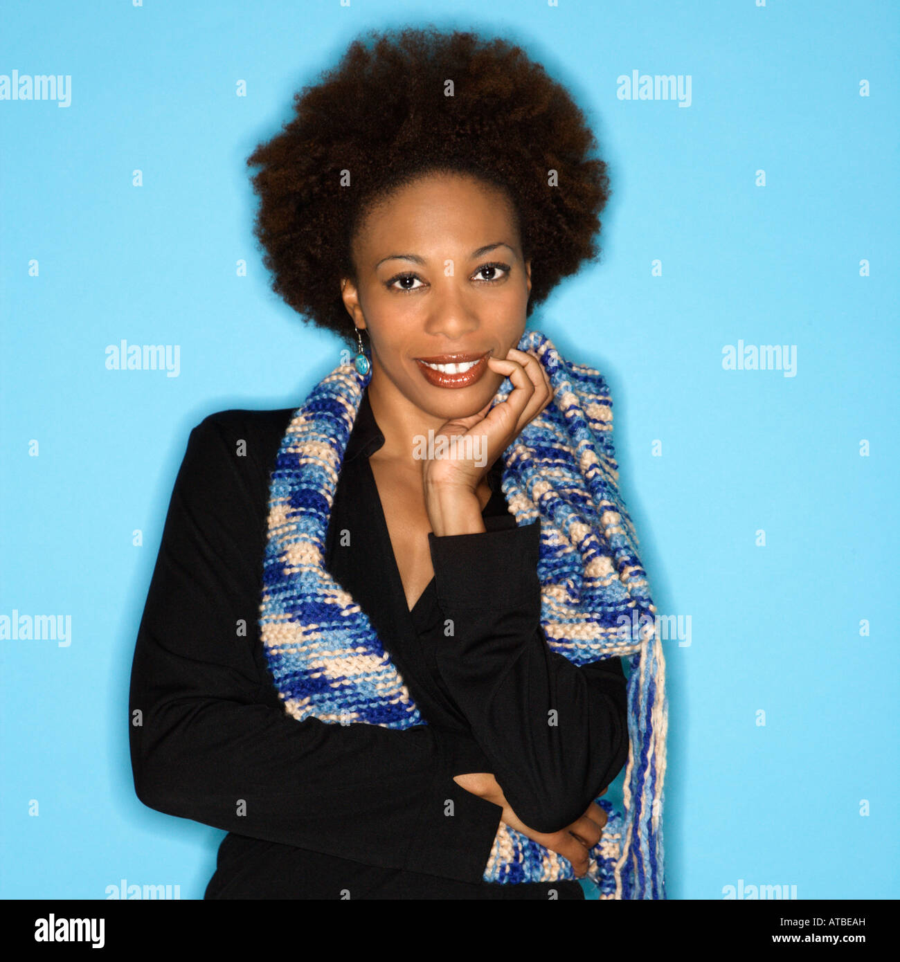 Pretty woman smiling against blue background Stock Photo - Alamy