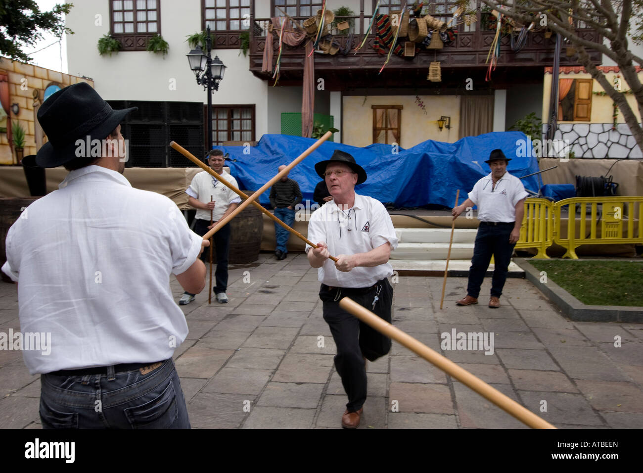 Two men dressed in traditional Tenerife costumes playing the game of ...
