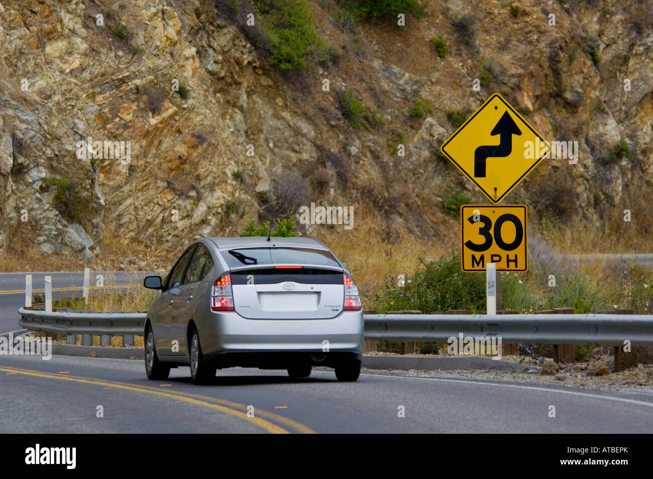 Car and speed saftey warning sign on curve along Highway One 1Big Sur ...