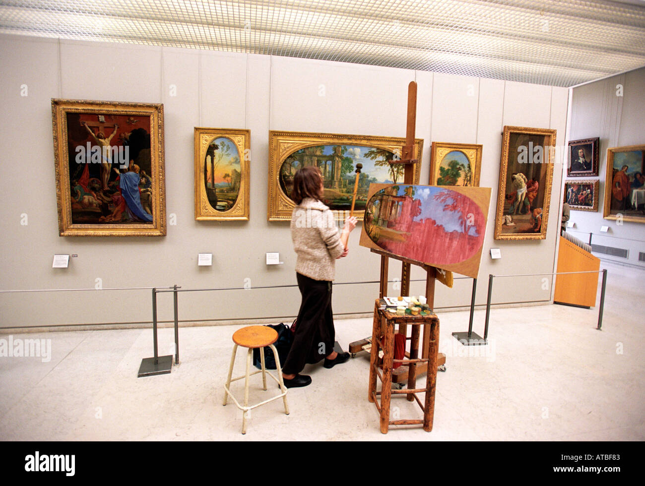 Painter copying a painting in The Louvre museum in Paris France Stock ...