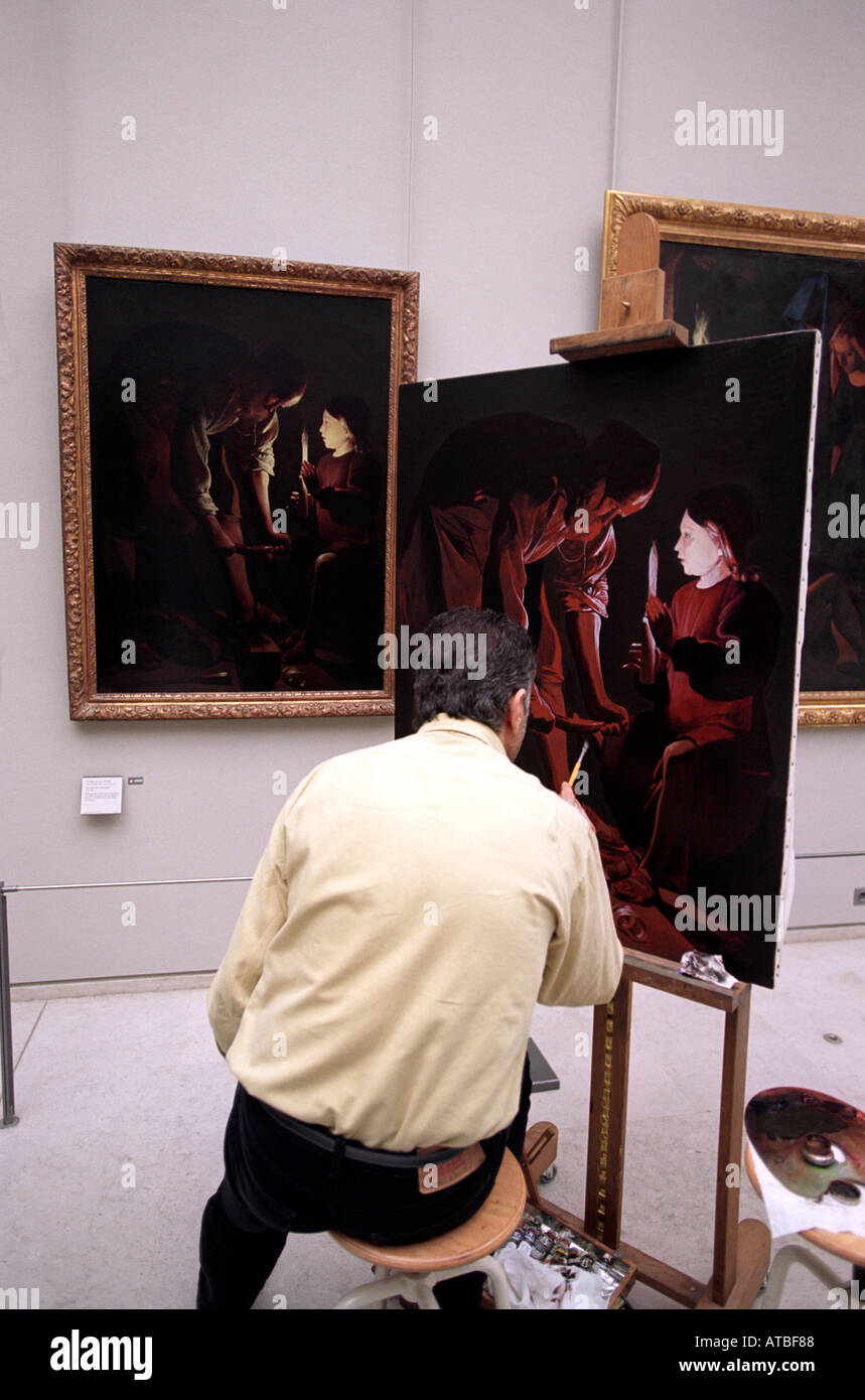 An artist copies a painting in the Louvre museum in Paris France Stock ...