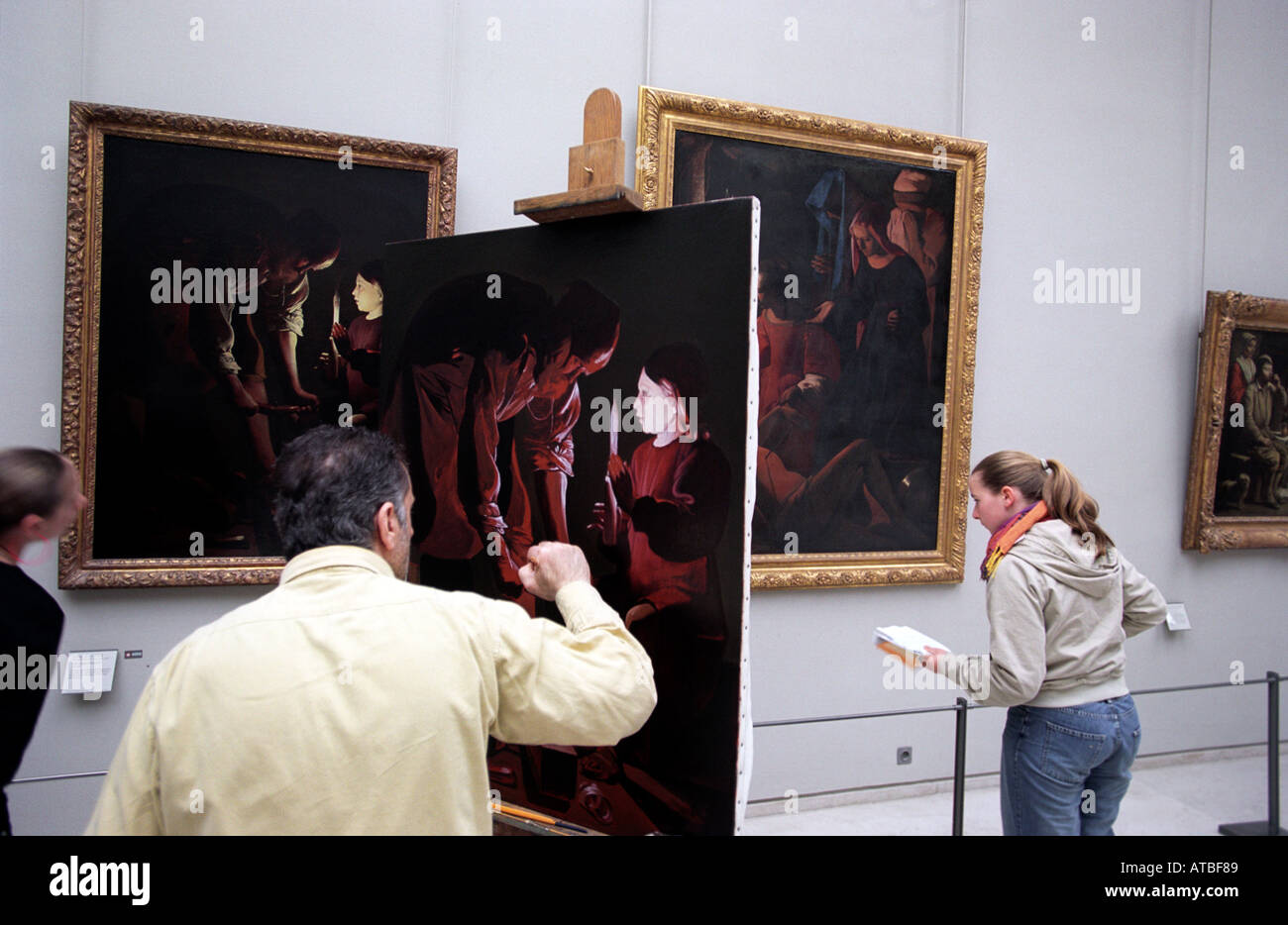 An artist copies a painting in the Louvre museum in Paris France Stock ...