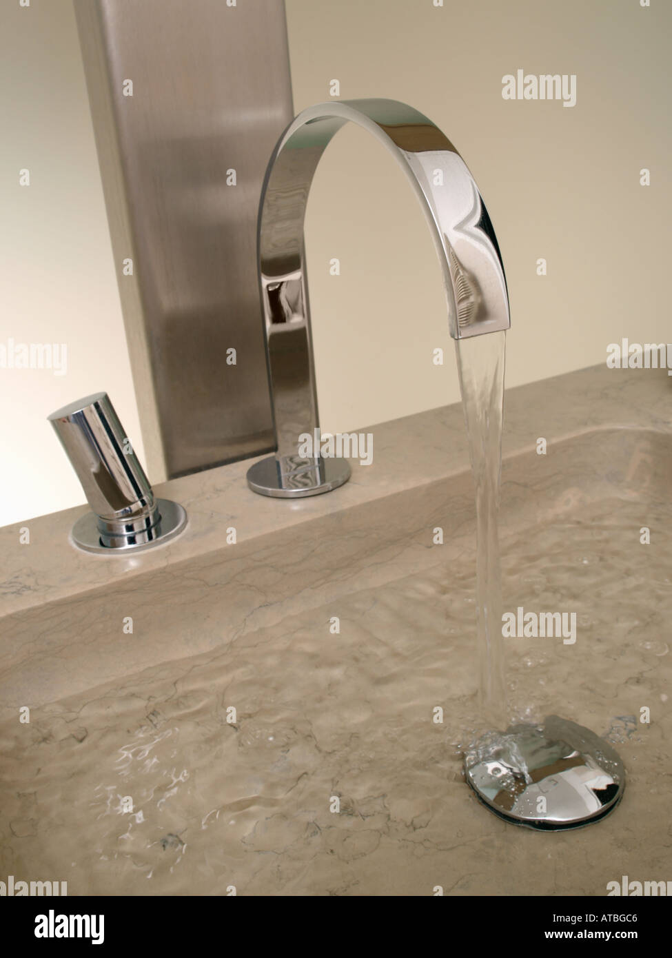 Modern design faucet tap in stainless steel with running water and ...