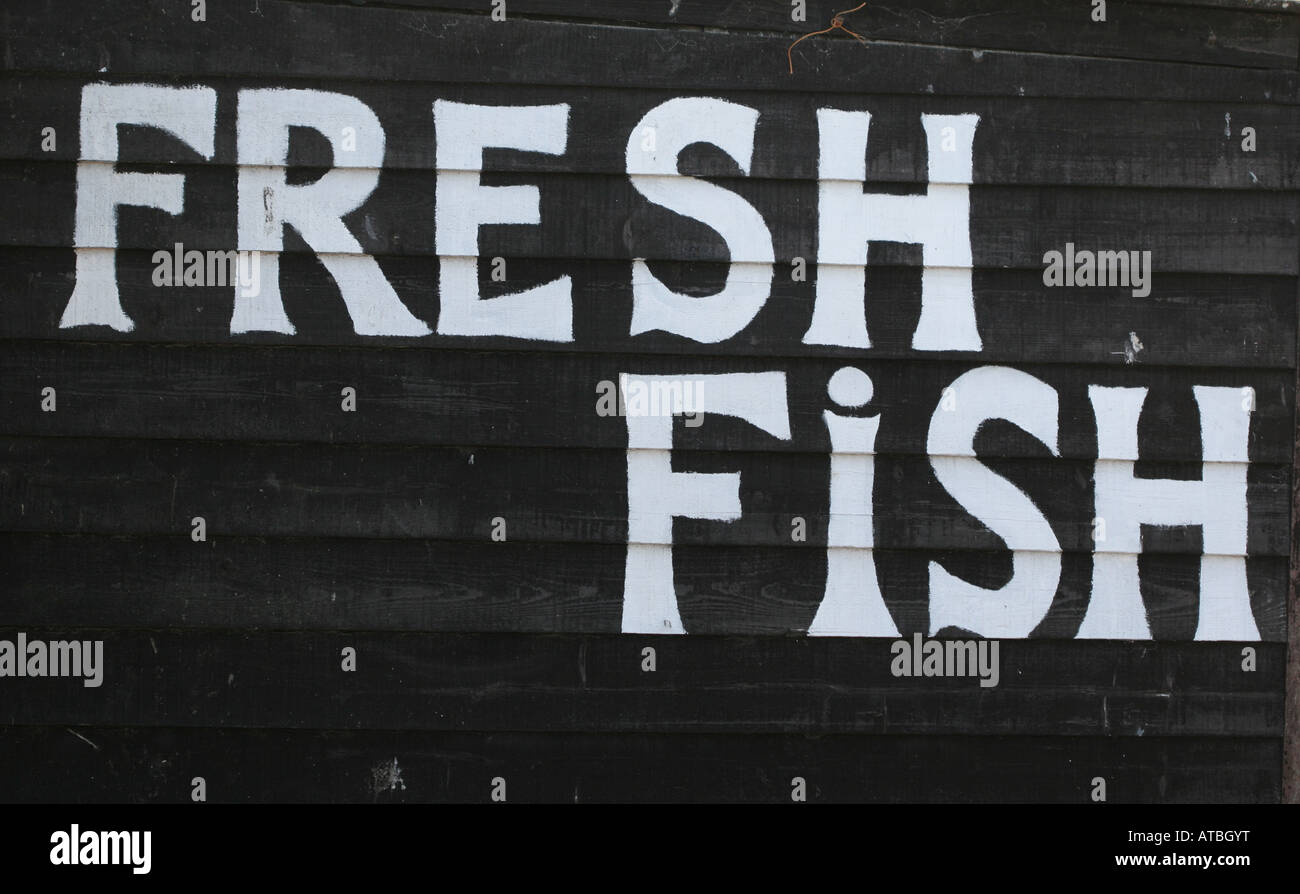Fresh Fish sign painted in white paint on black wall Stock Photo - Alamy