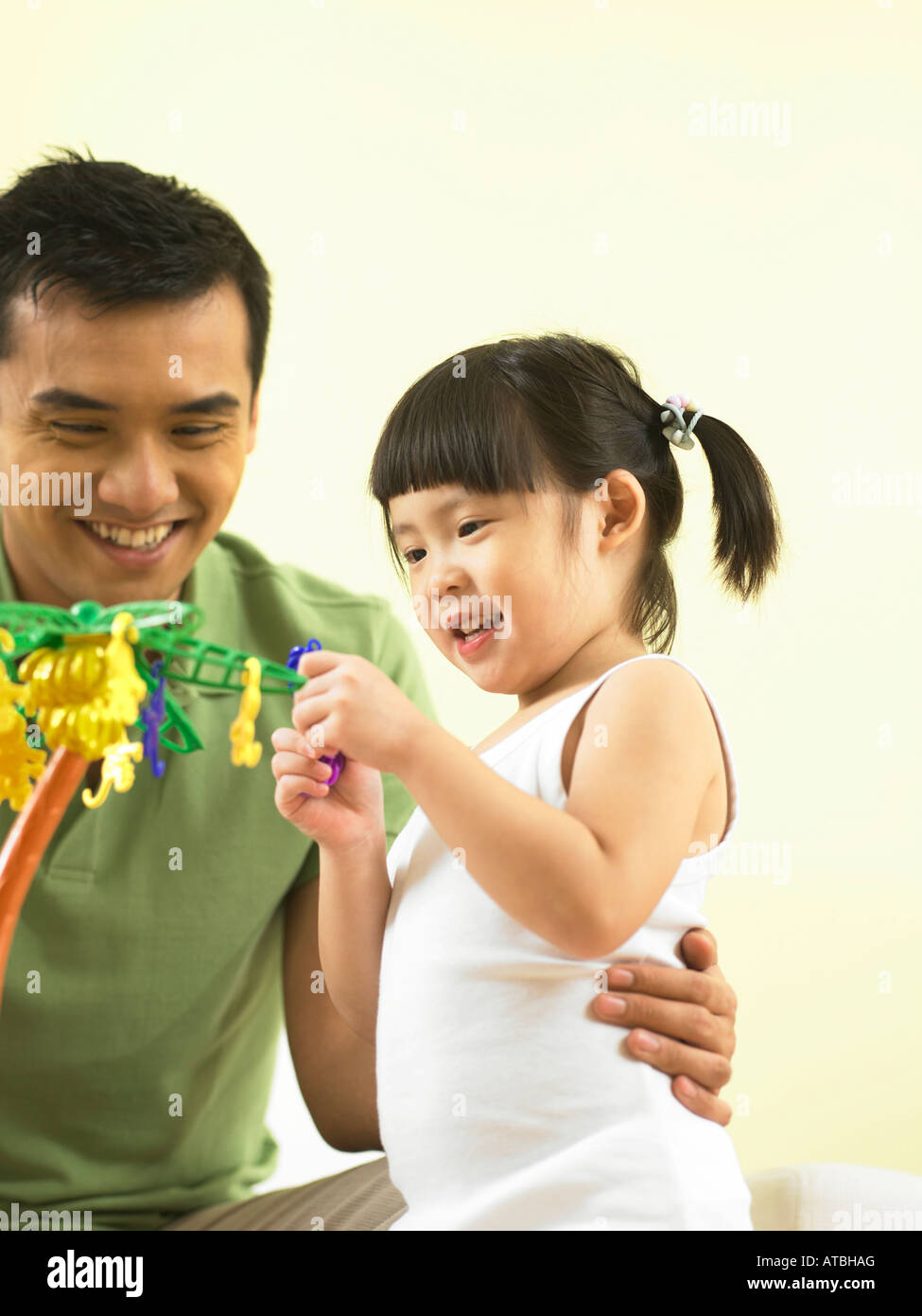 father and daughter playing toy together Stock Photo - Alamy