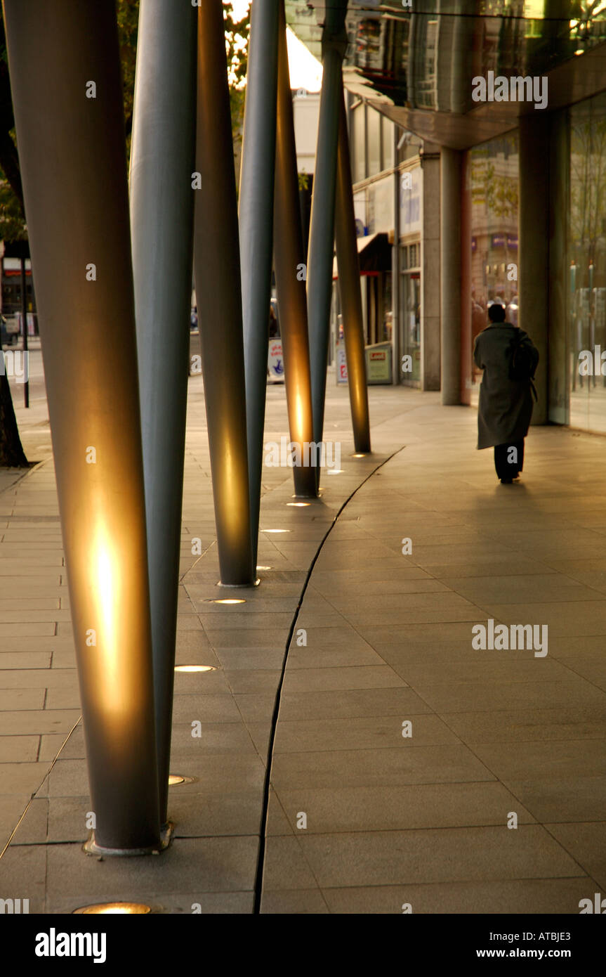 lone pedestrian walking through modern office building entrance Stock ...