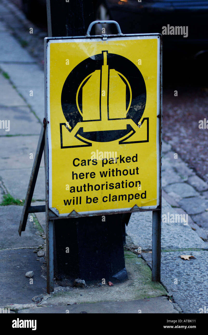 sign warning of wheel clamping for unauthorised parking Stock Photo - Alamy
