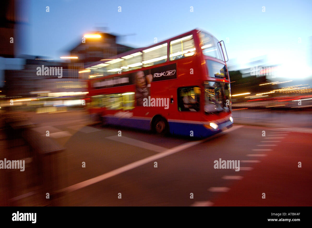 london double decker bus at night with motion blur to show movement ...