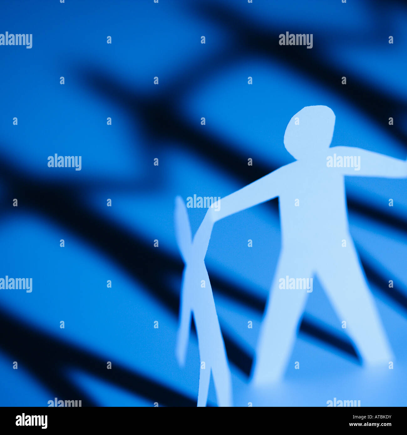 Paper cutout adult man and boy holding hands Stock Photo - Alamy