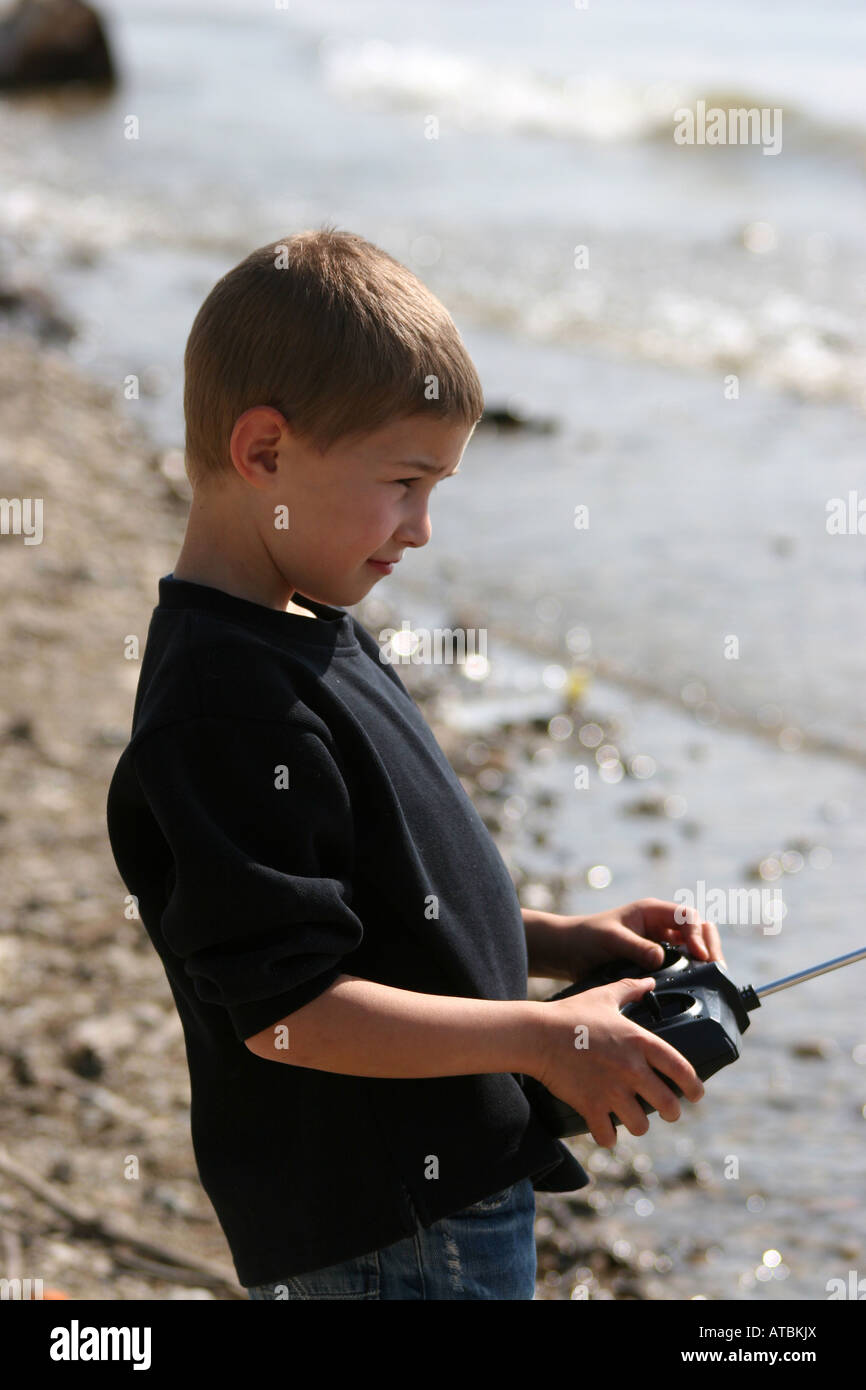 boy with remote control on the bank Stock Photo - Alamy