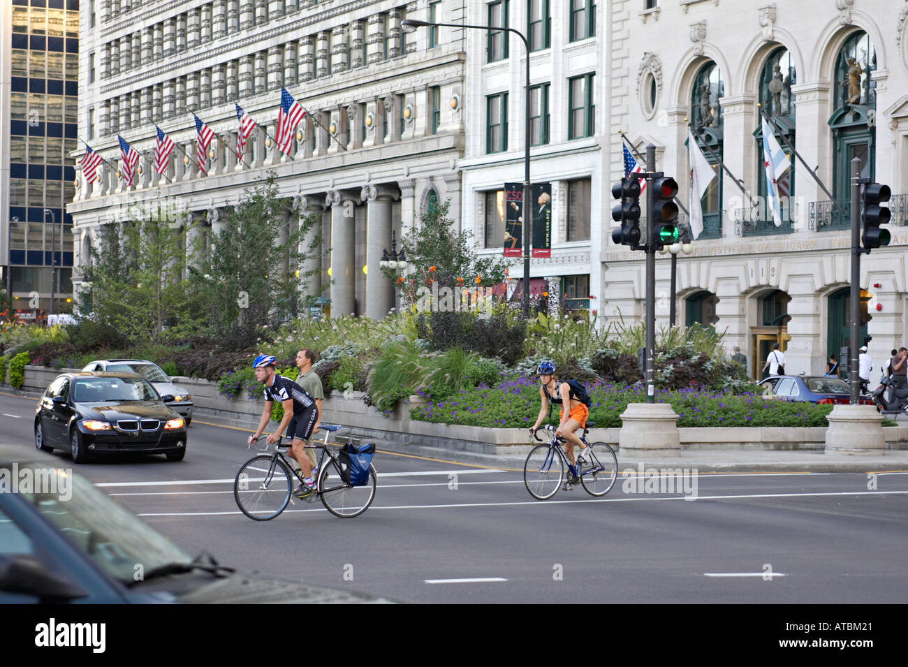 STREET SCENE Chicago Illinois Man and woman ride road bikes in ...