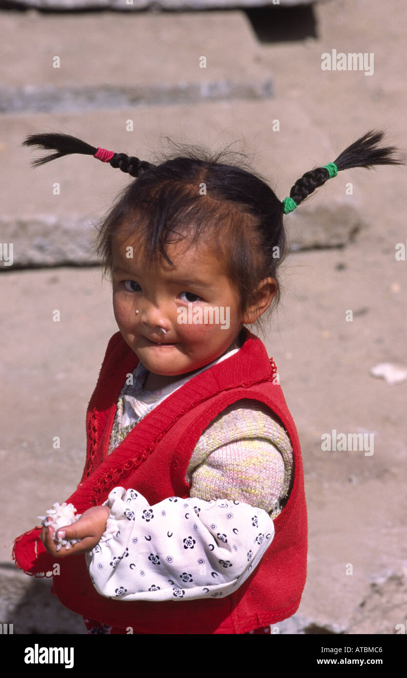 Chinese girl eating rice. Litang, Sichuan, China Stock Photo - Alamy