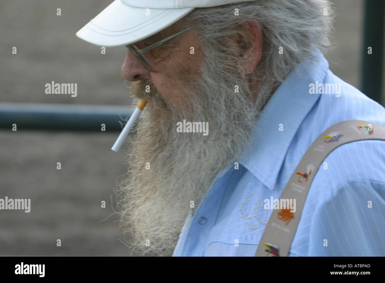 Older man having a cigarette at the rodeo Stock Photo - Alamy