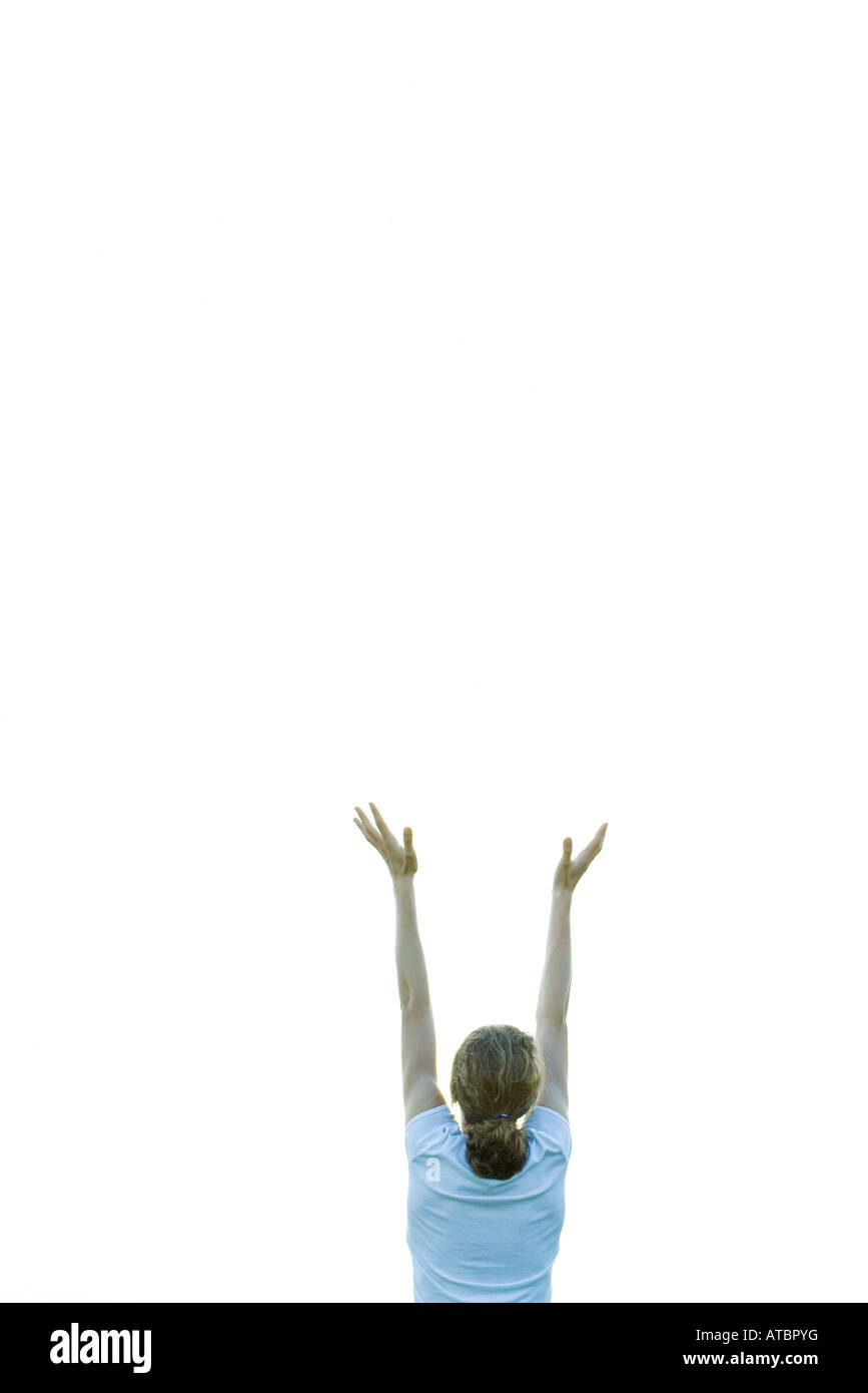 Teenage girl with arms raised, rear view Stock Photo - Alamy