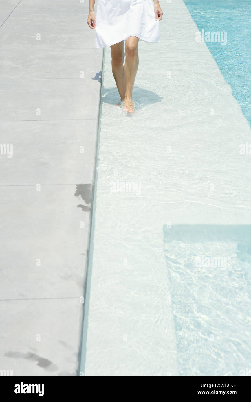 Woman walking on shallow swimming pool ledge, cropped view Stock Photo ...