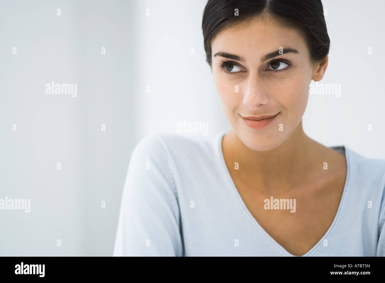 Woman looking up, smiling, head and shoulders, portrait Stock Photo - Alamy