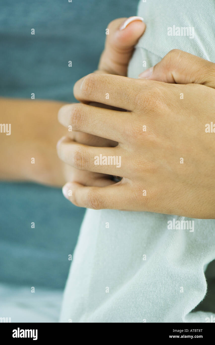 Hands clasping arm, cropped view Stock Photo - Alamy