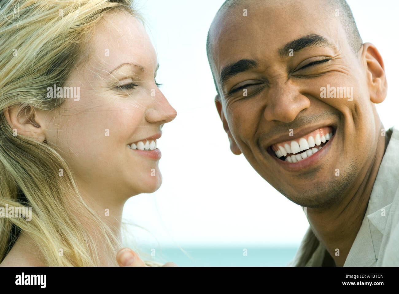 Couple laughing together, man looking at camera, close-up Stock Photo ...
