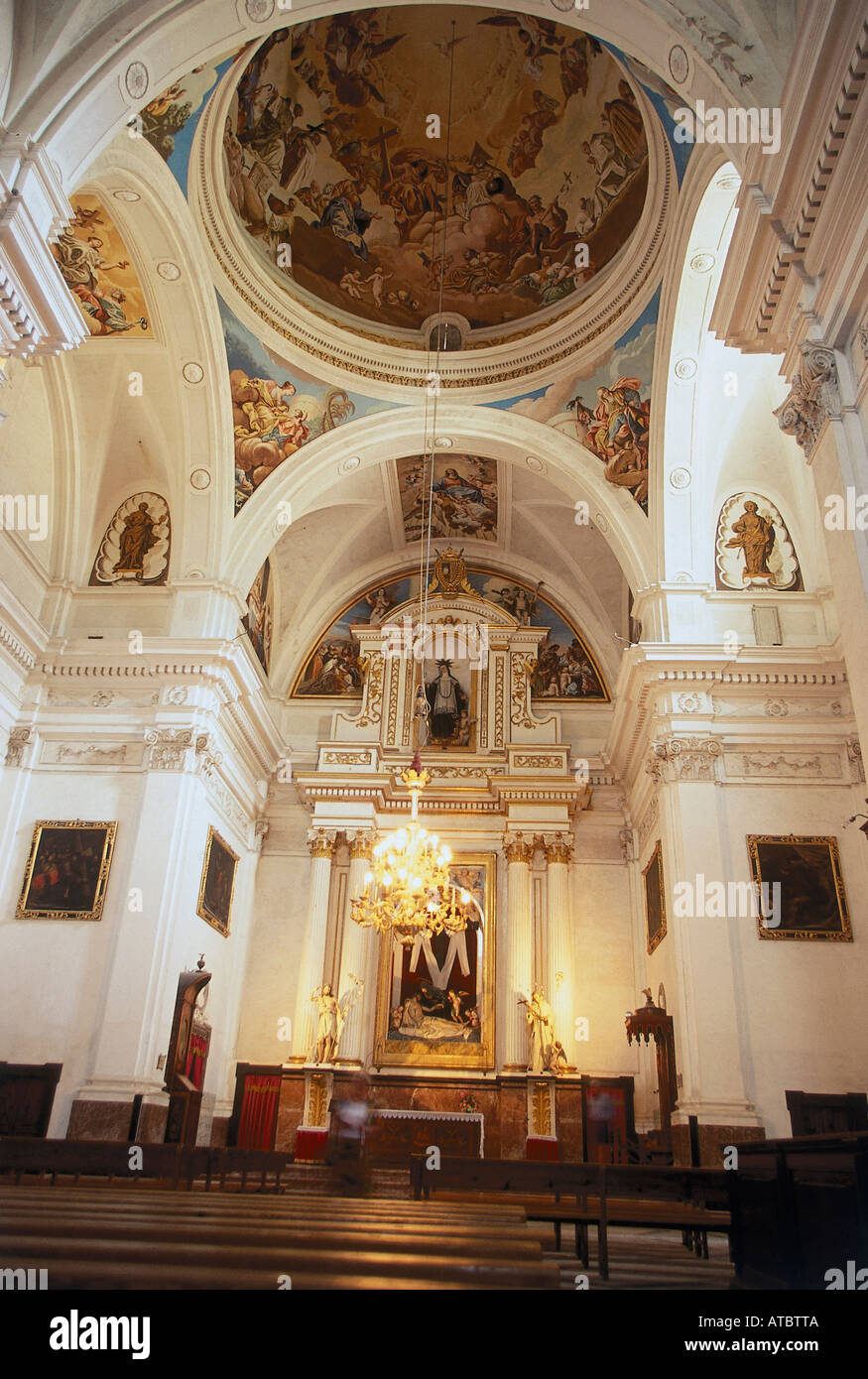 A glowing chandelier illuminates the church decorated with Baroque ...