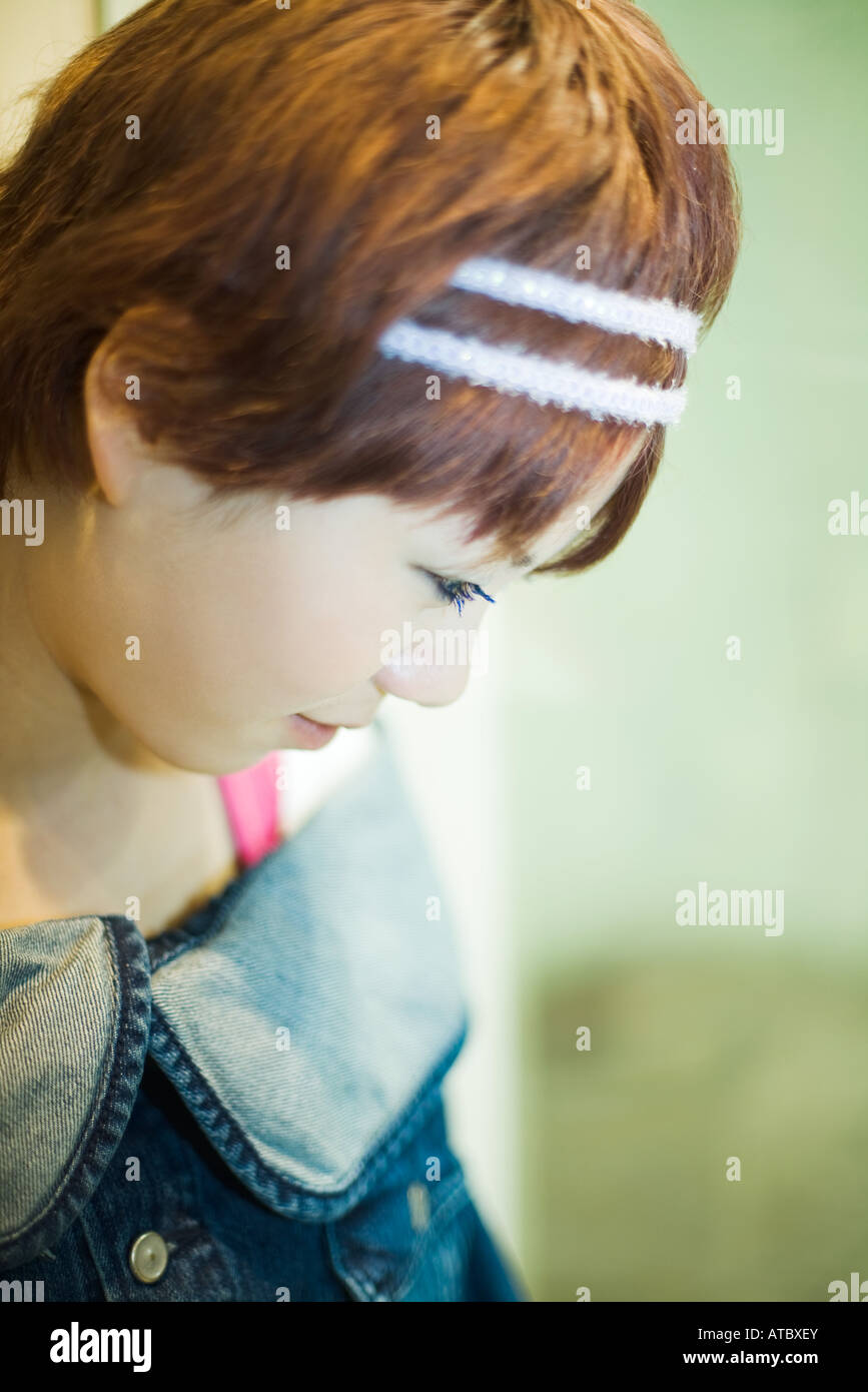 Young woman looking down, head down, side view Stock Photo - Alamy