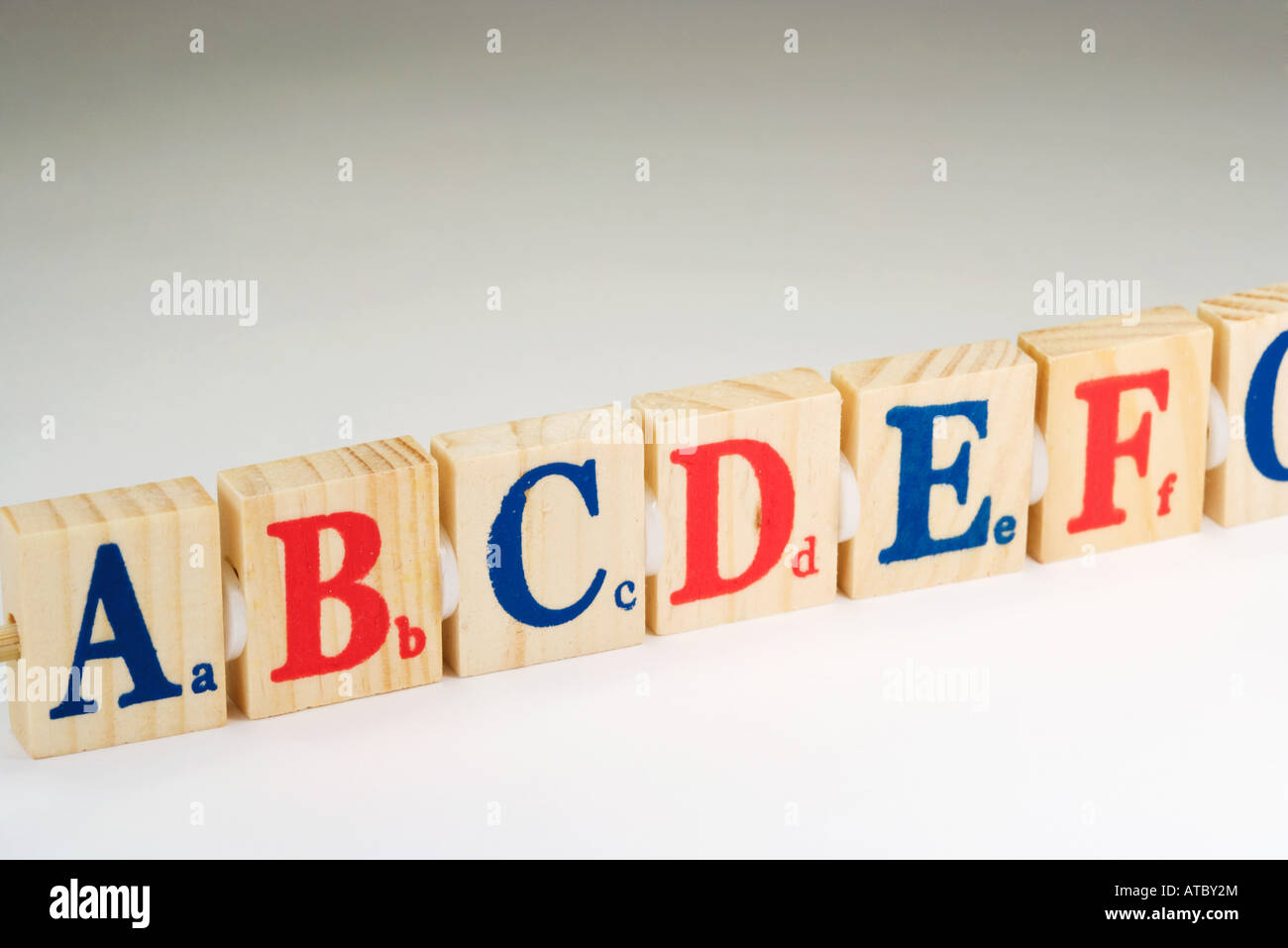 Wooden alphabet blocks in a row, close-up Stock Photo - Alamy