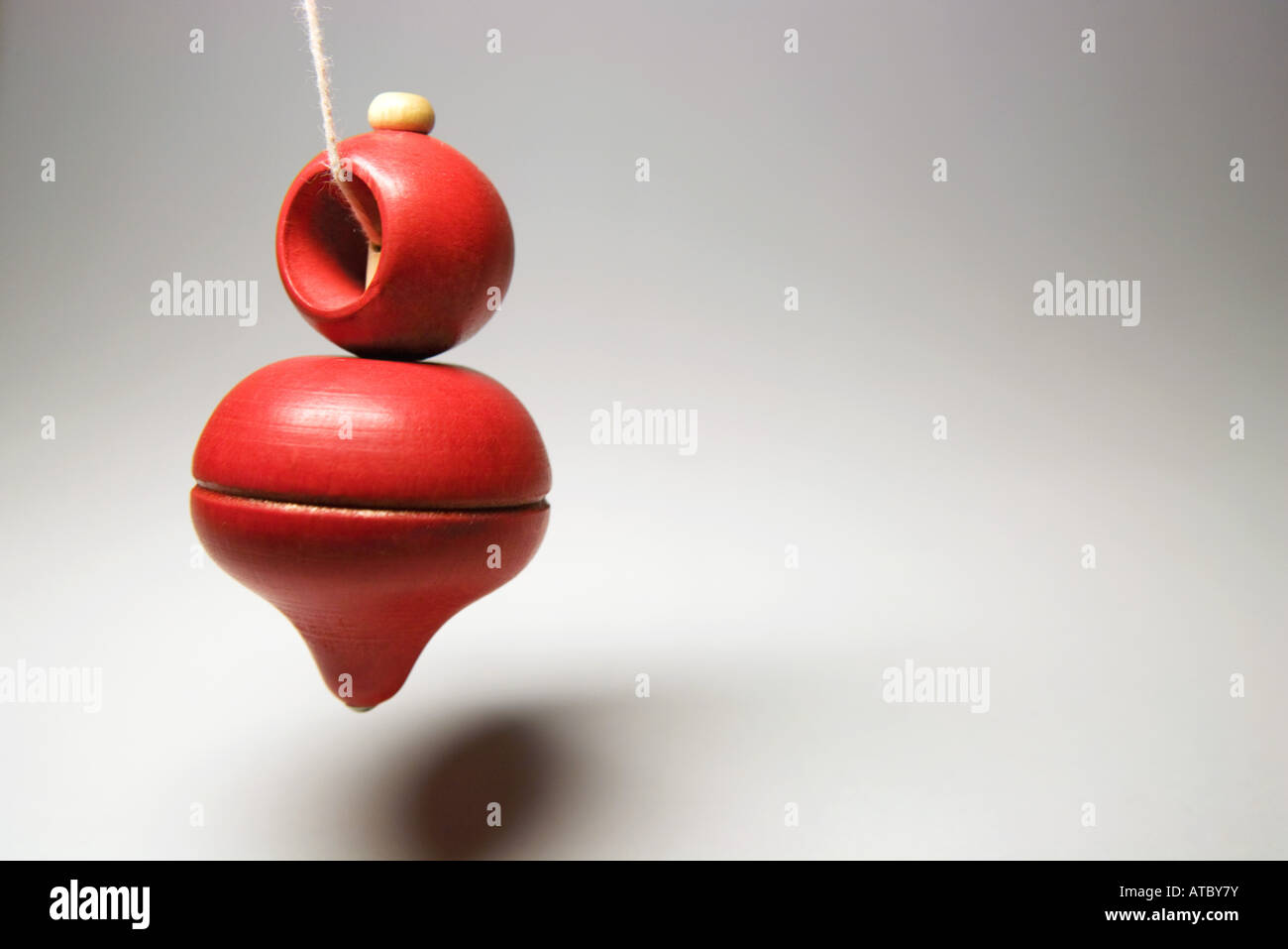Spinning top hanging on string, close-up Stock Photo - Alamy